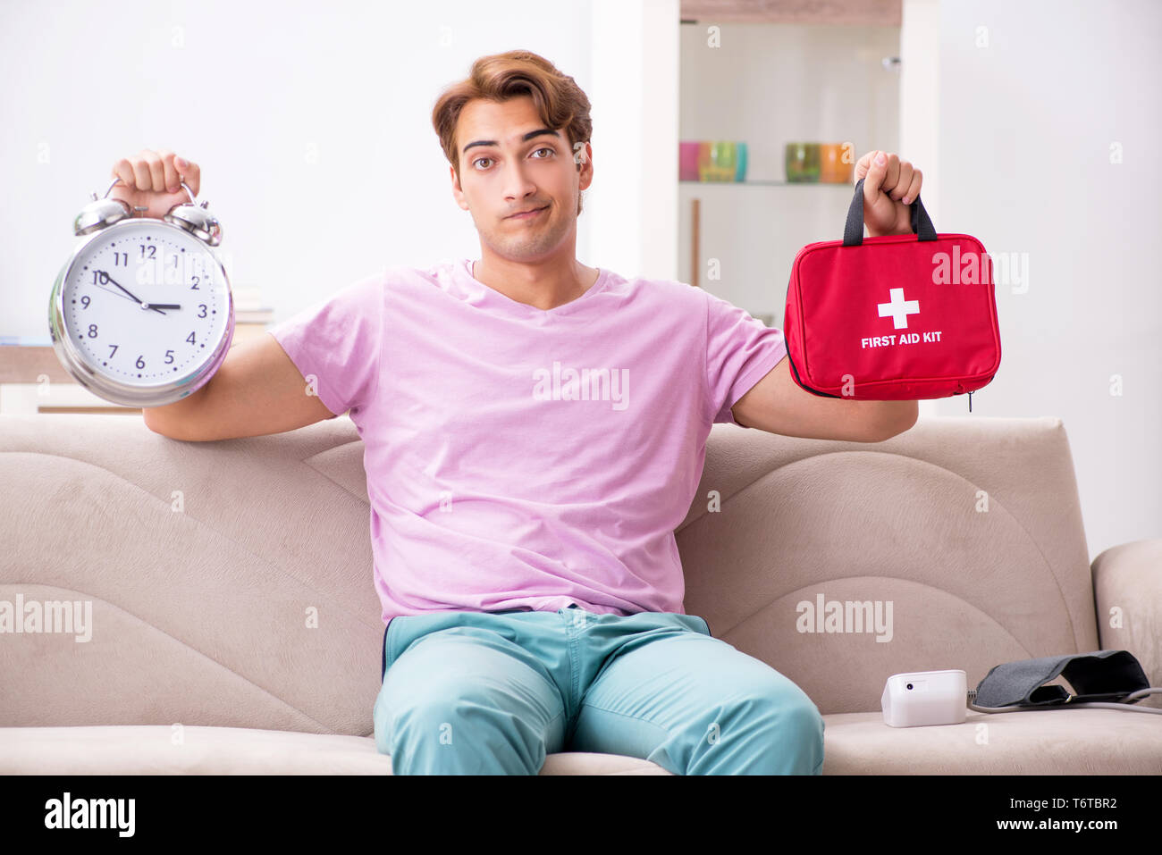 Sick man at home with first aid kit Stock Photo - Alamy