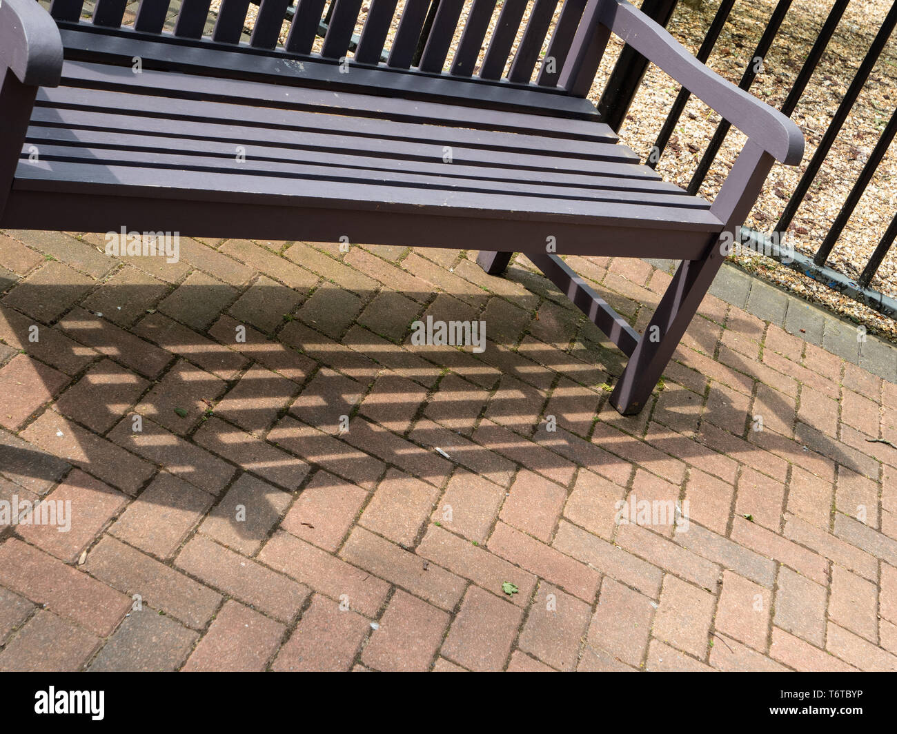 Park bench with shadow, in the sunshine Stock Photo - Alamy