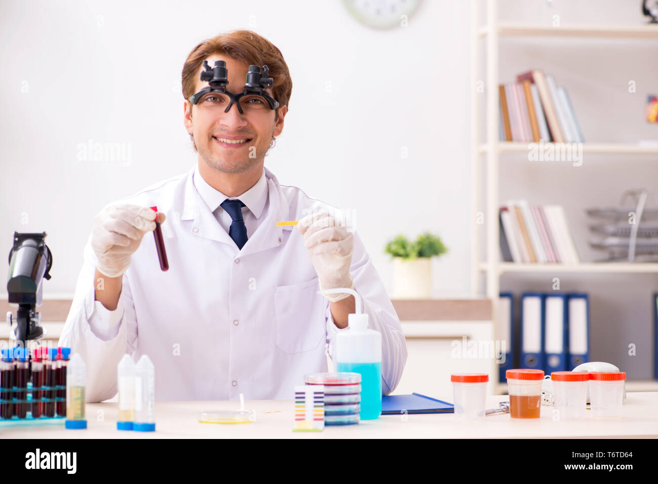 Chemist in the lab checking with ph strips Stock Photo - Alamy