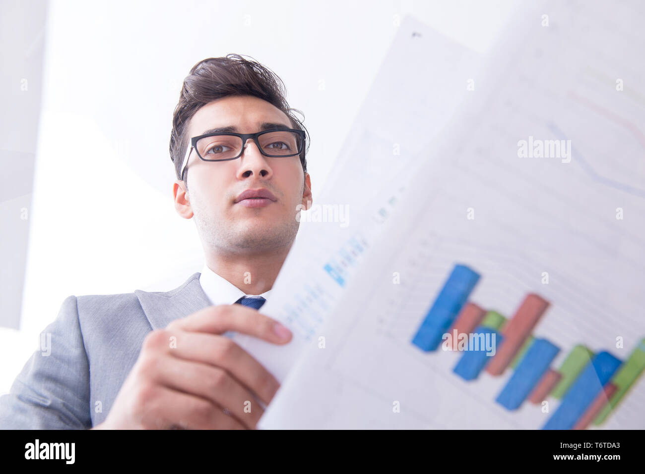 Businessman looking at financial charts and graphs Stock Photo - Alamy