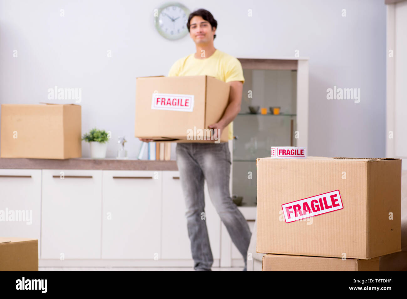 Man moving house and relocating with fragile items Stock Photo - Alamy