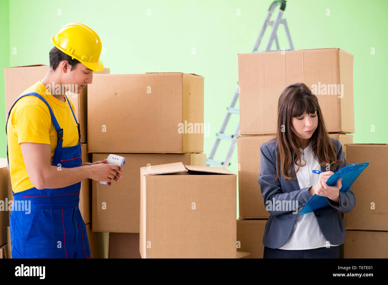 Woman boss and man contractor working with boxes delivery Stock Photo ...