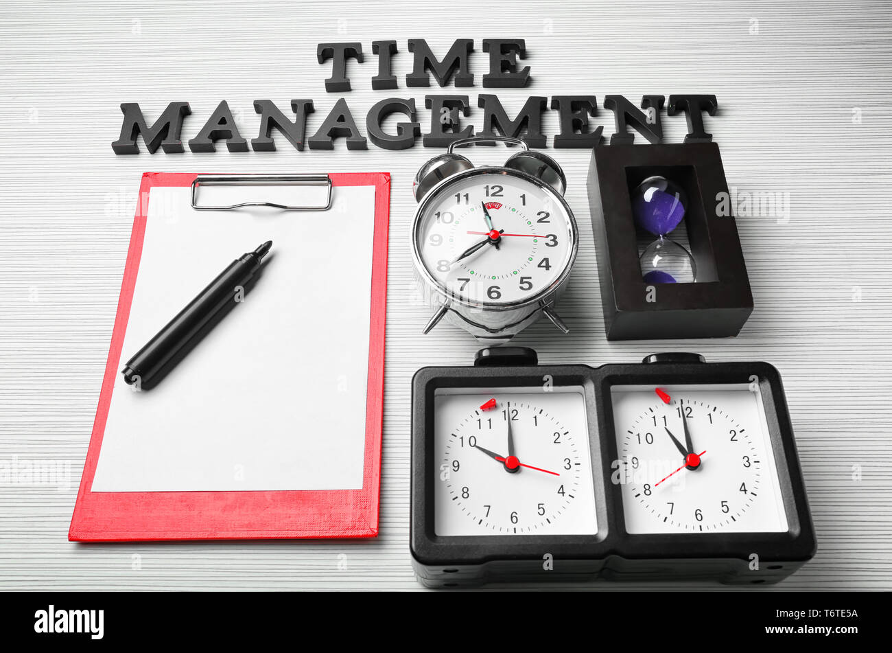 Composition with different clocks, clipboard and phrase "Time ...