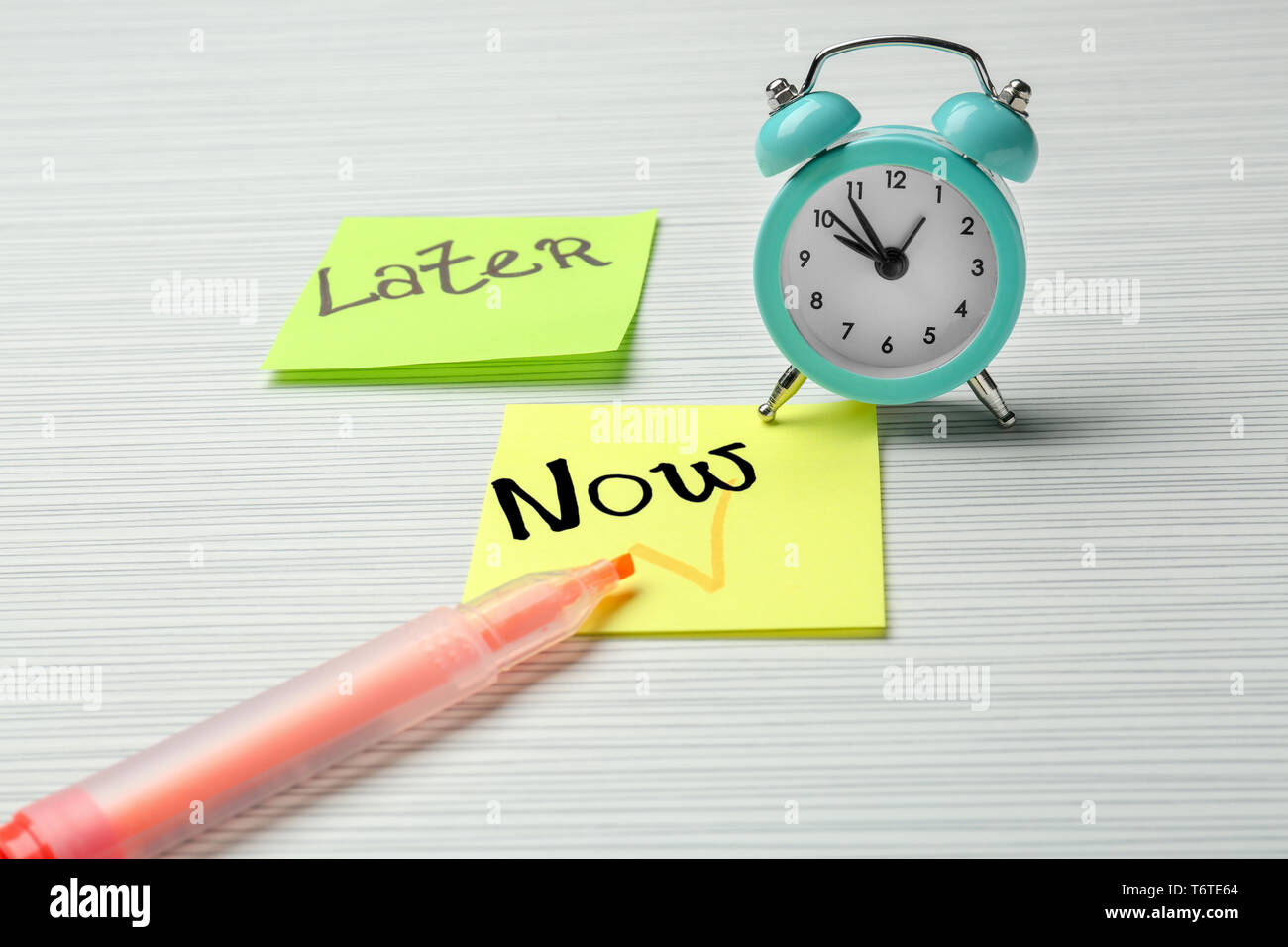 Alarm clock and paper sheets for notes on table. Time management ...