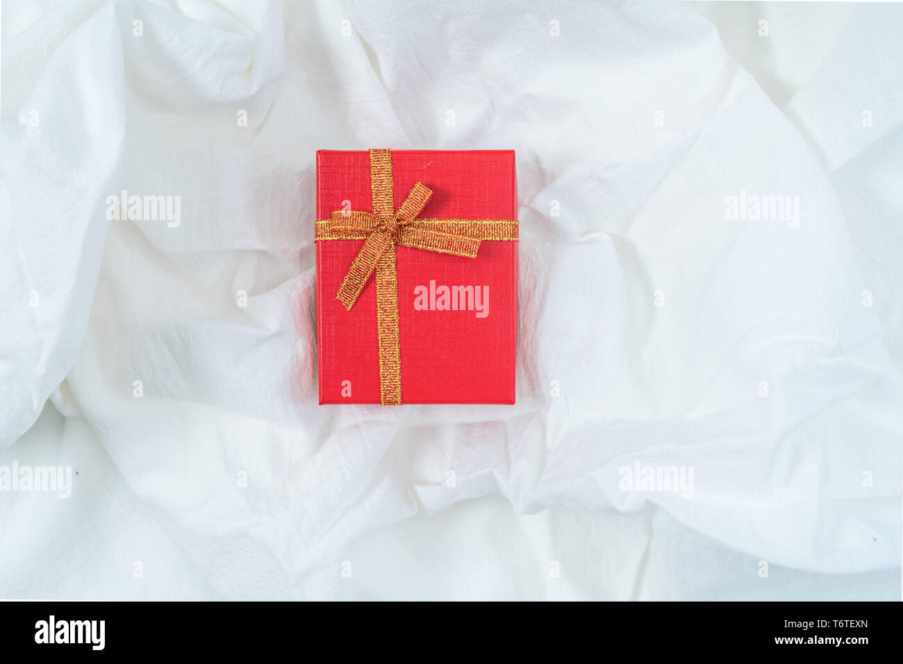 Red cardboard box for gifts, isolated, white fabric texture background ...