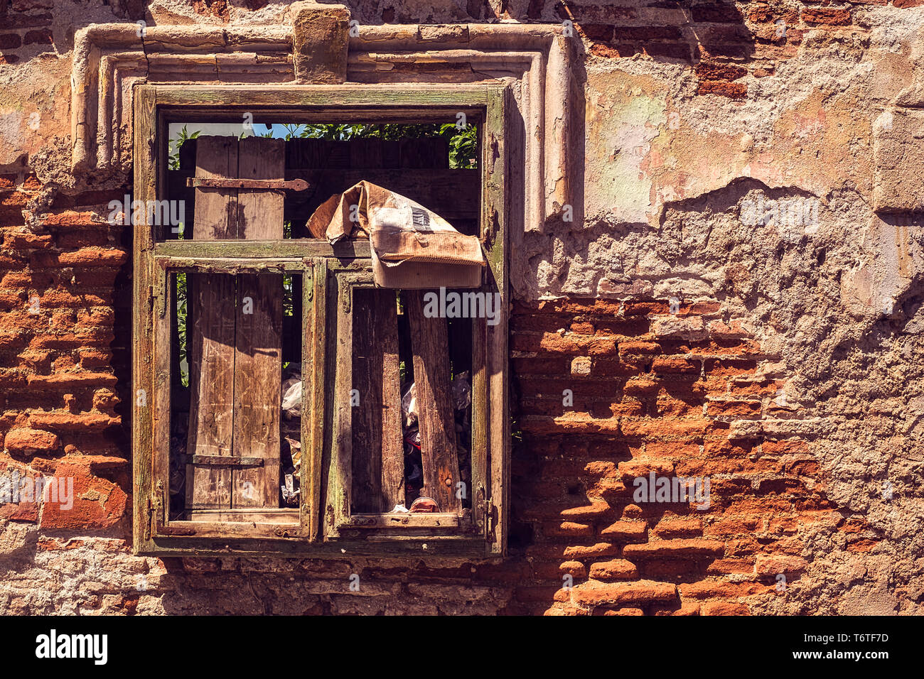 window of a derelict house full of garbage Stock Photo - Alamy