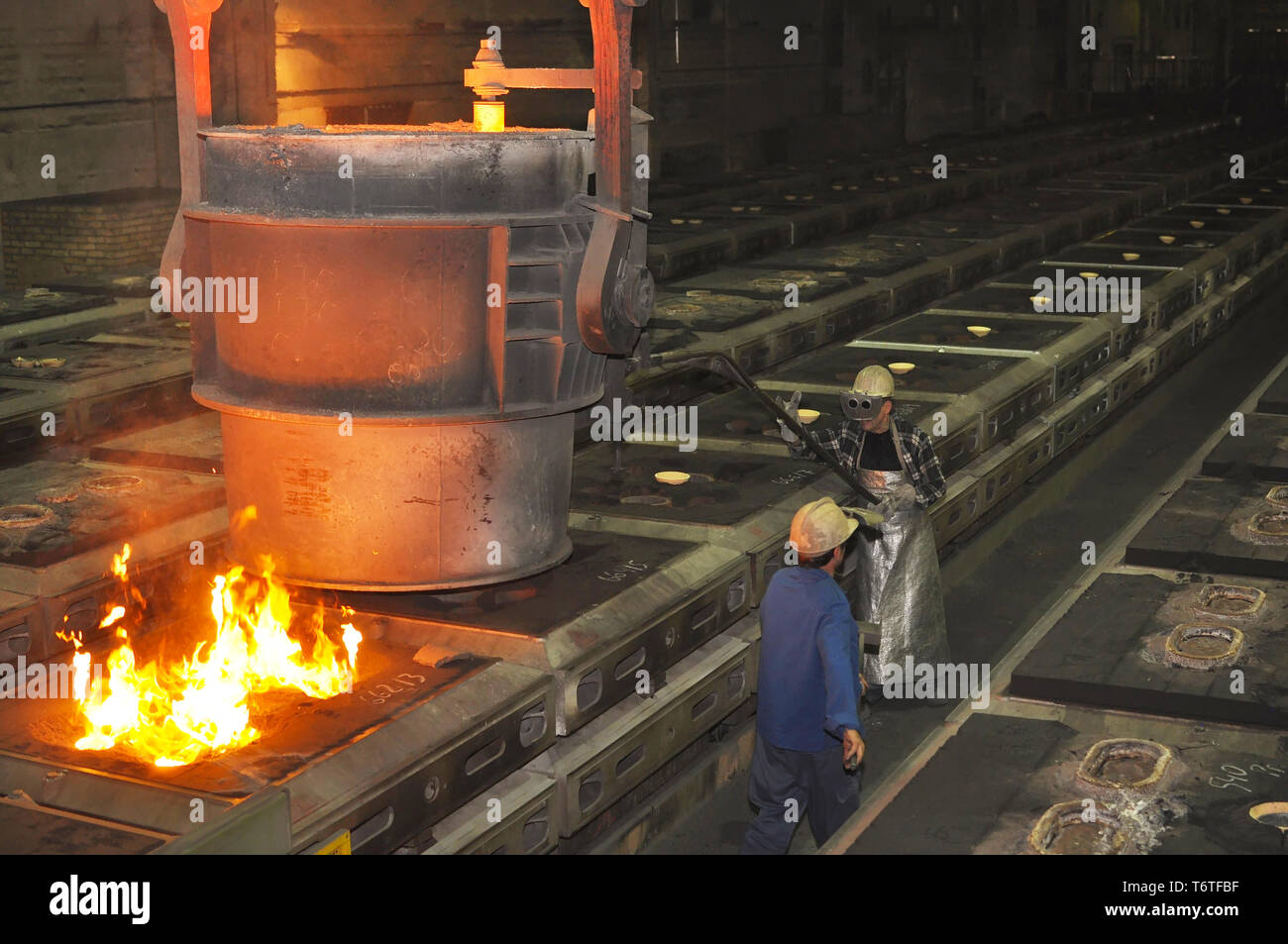 Production of metal components in a foundry - group of workers Stock ...