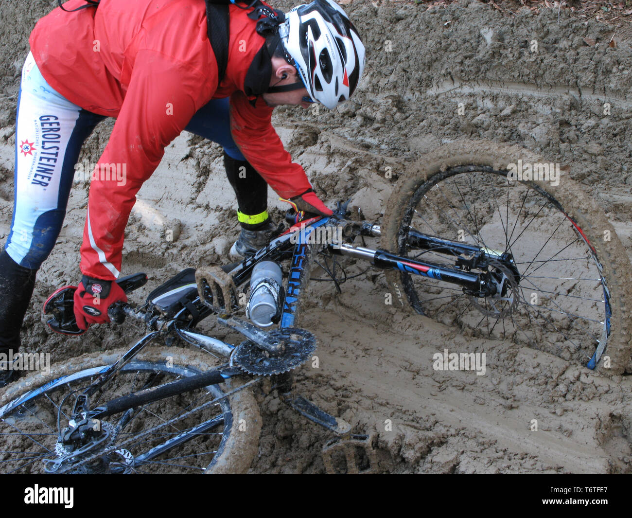 a cyclist fell bike in the mud Stock Photo - Alamy