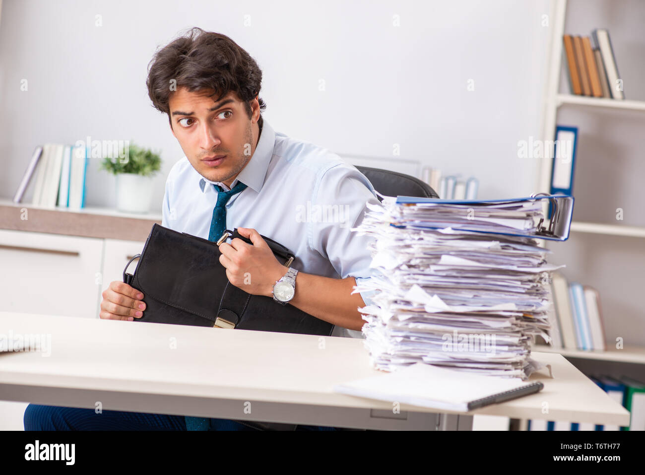 Overloaded busy employee with too much work and paperwork Stock Photo ...