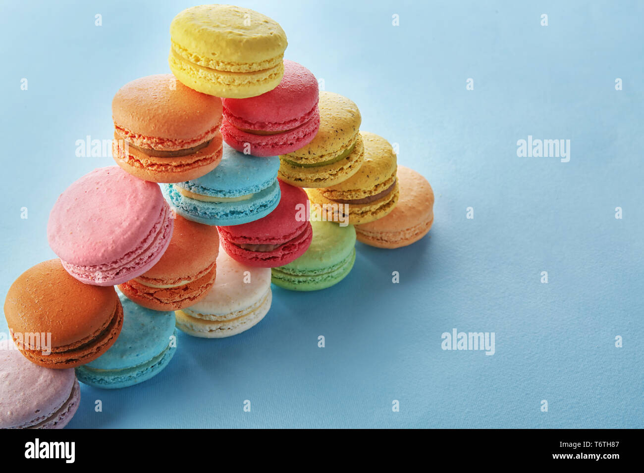 Delicious macarons on color background Stock Photo - Alamy