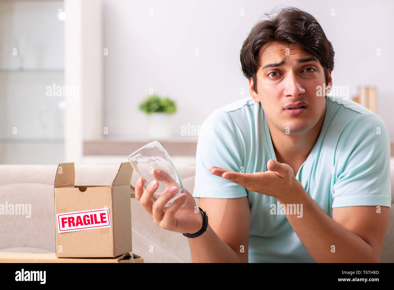 Man opening fragile parcel ordered from internet Stock Photo - Alamy