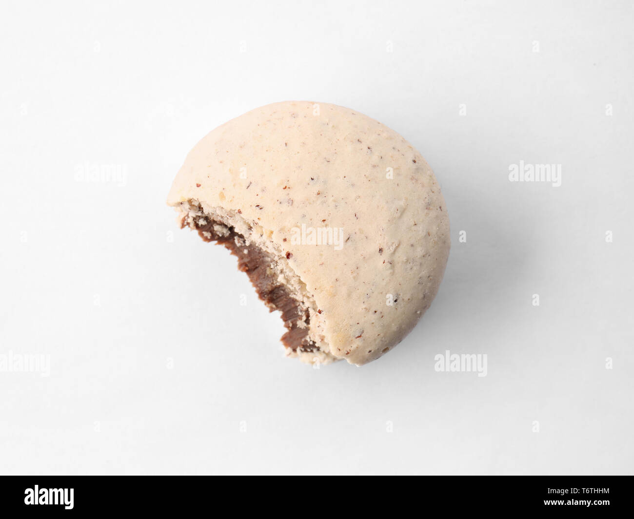 Tasty macaron with bite mark on white background Stock Photo - Alamy