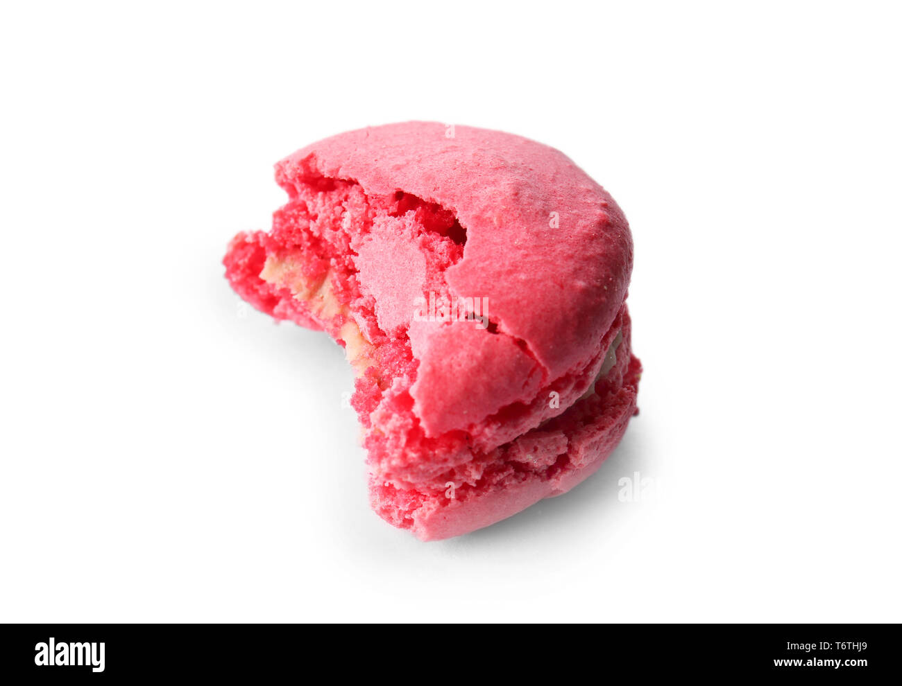 Tasty pink macaron with bite mark on white background Stock Photo - Alamy