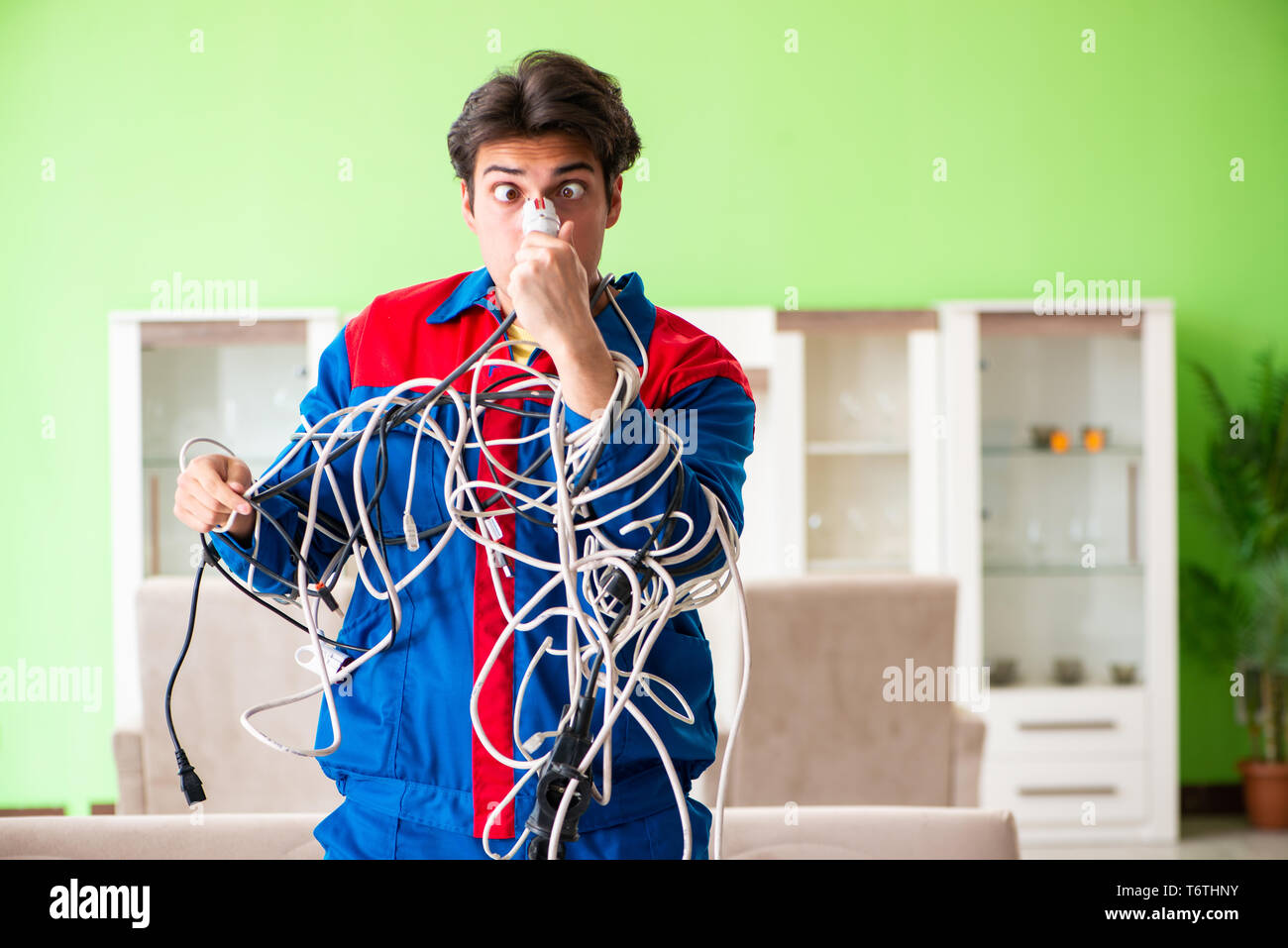 Electrician contractor with tangled cables Stock Photo - Alamy