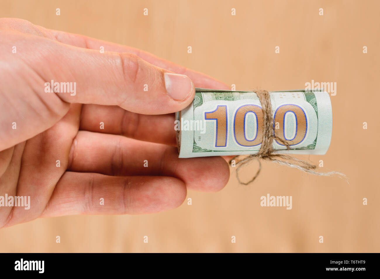 A man's hand holding 100 hundred banknotes, a transfer of money. 2019 ...