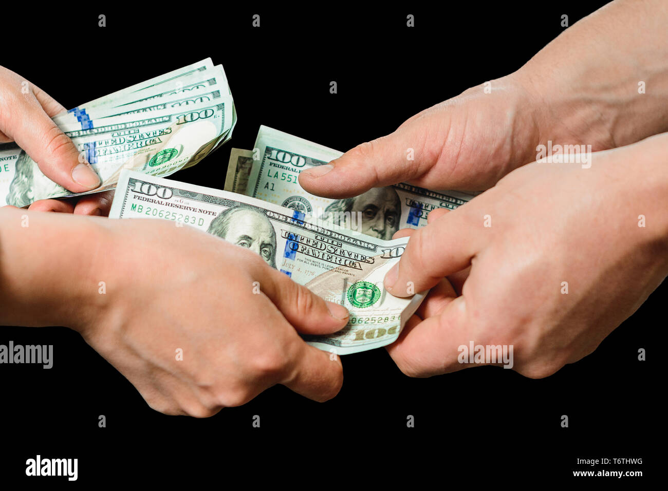The hand, giving money, is isolated on a black background. 2019 Stock ...