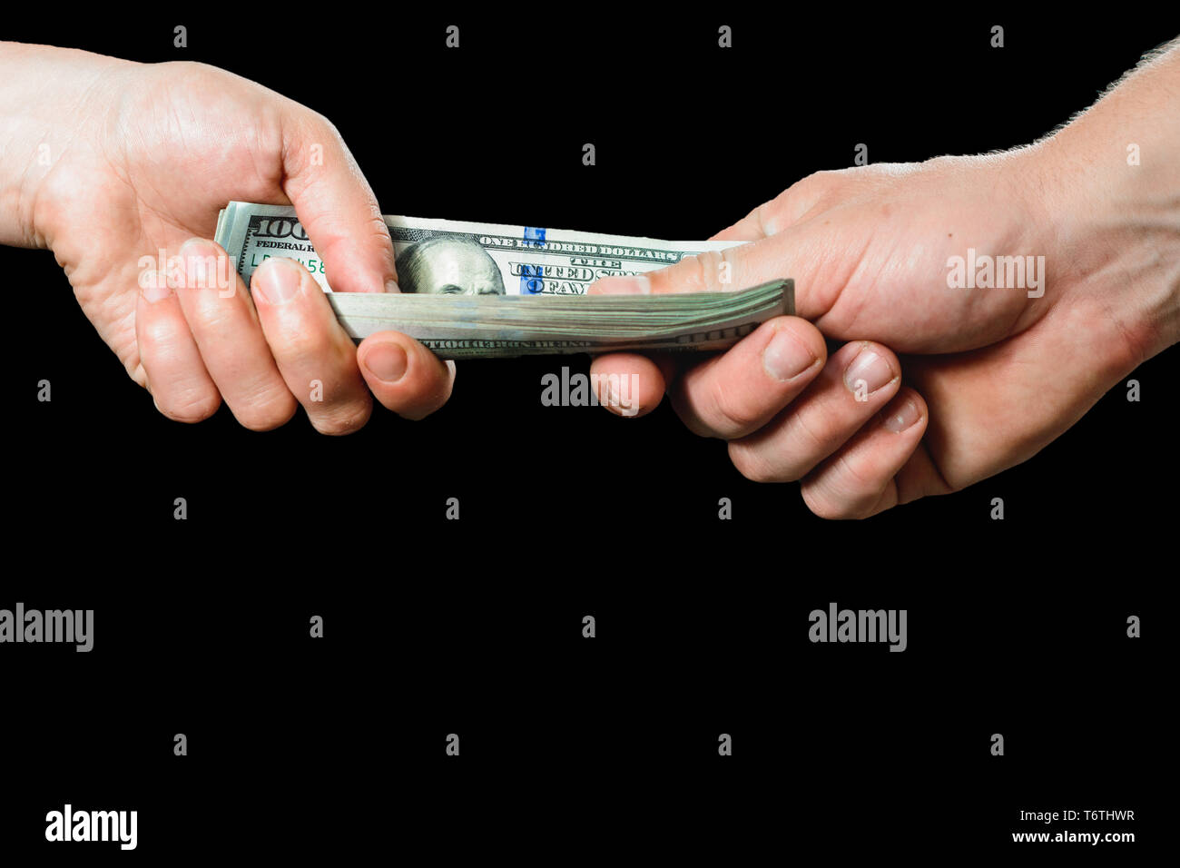 The hand, giving money, is isolated on a black background. 2019 Stock ...