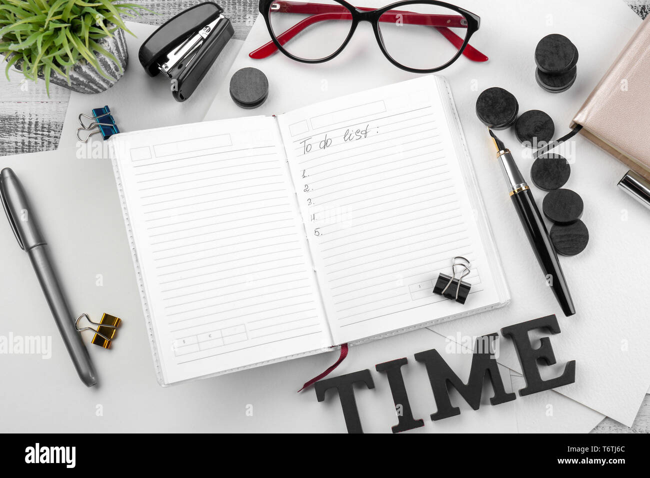 Composition with to-do list and stationery on table. Time management ...