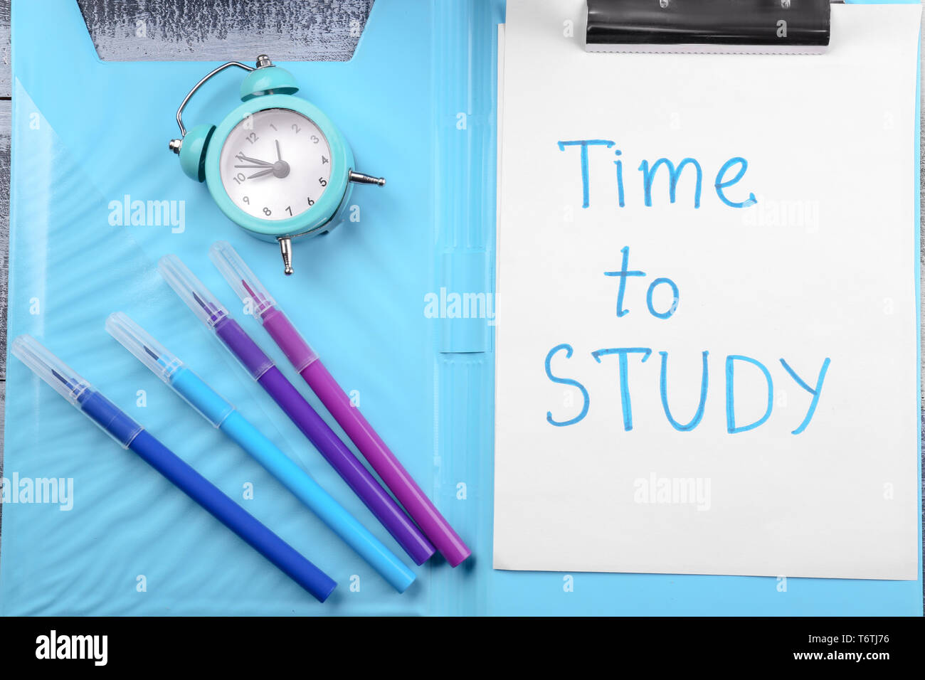 Composition with clipboard and inscription "Time to study" on table ...