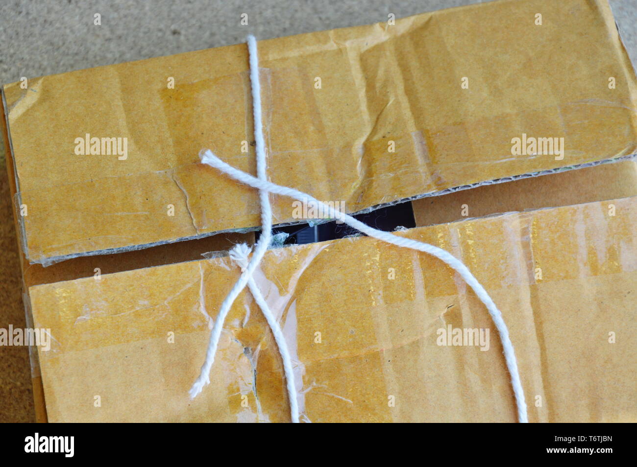 Brown paper parcel with rope torn open hi-res stock photography and ...