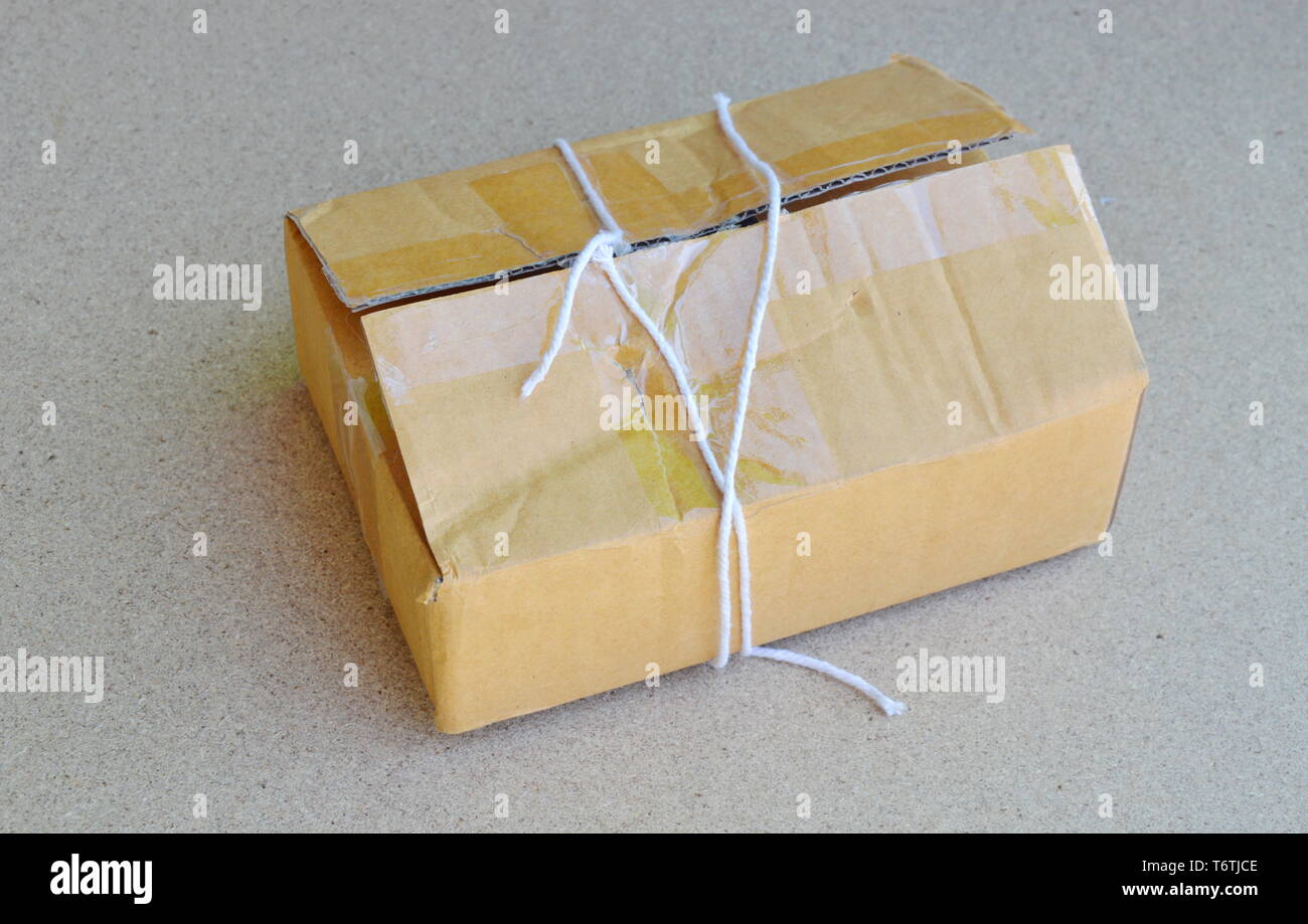 parcel rope cut and open brown postal box Stock Photo - Alamy