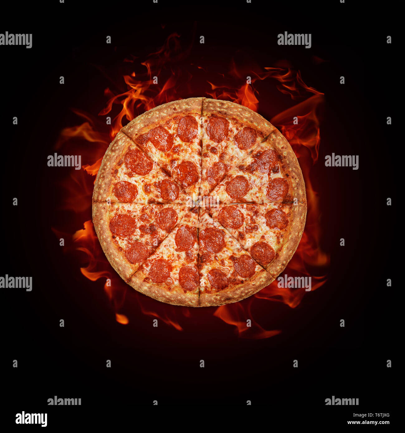 pepperoni pizza on fire on black background Stock Photo - Alamy