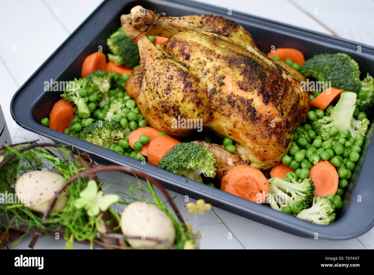 Roasted chicken with spring vegetables Stock Photo - Alamy
