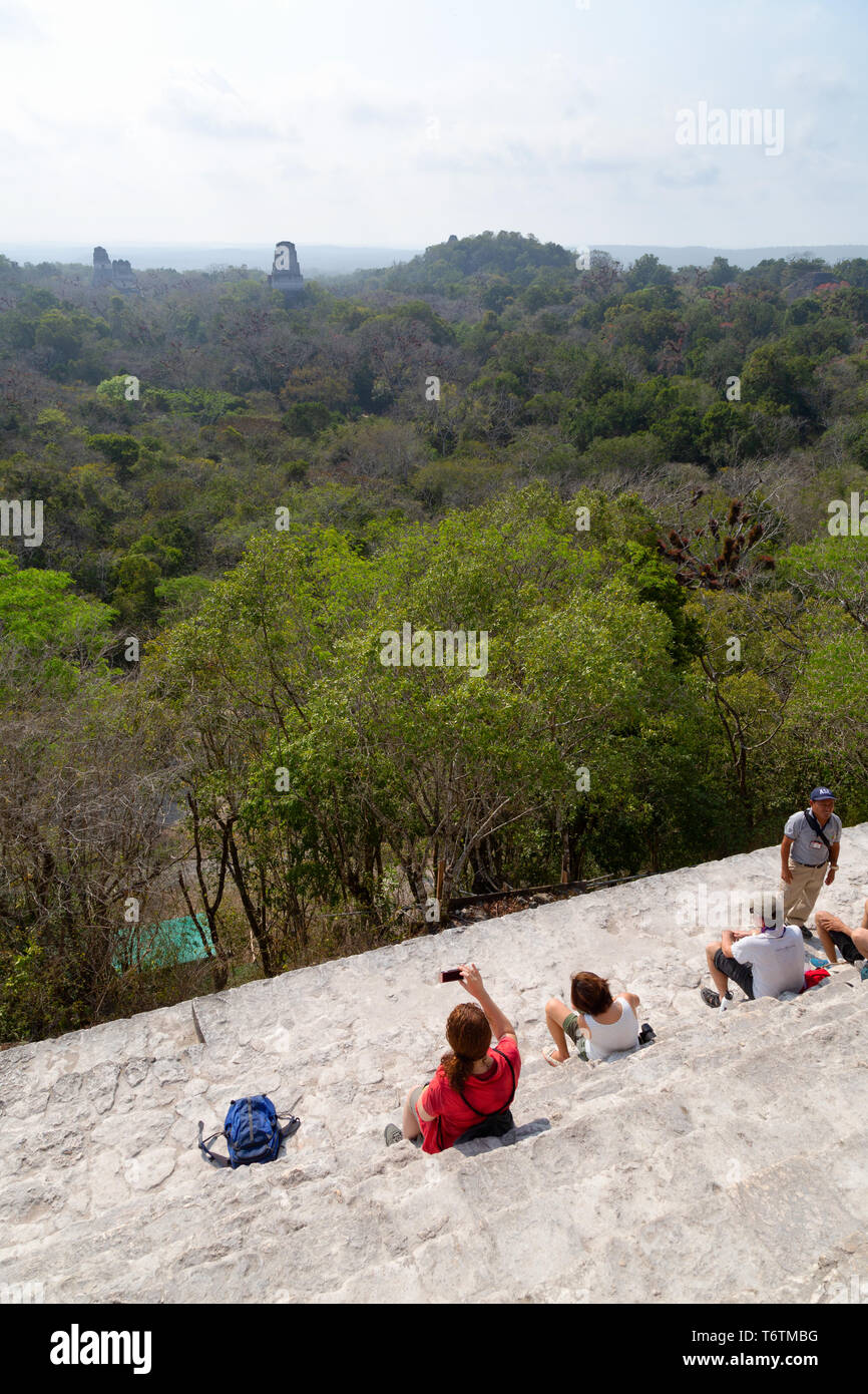 Tikal Guatemala - tourists at the top of Temple IV looking at other ...