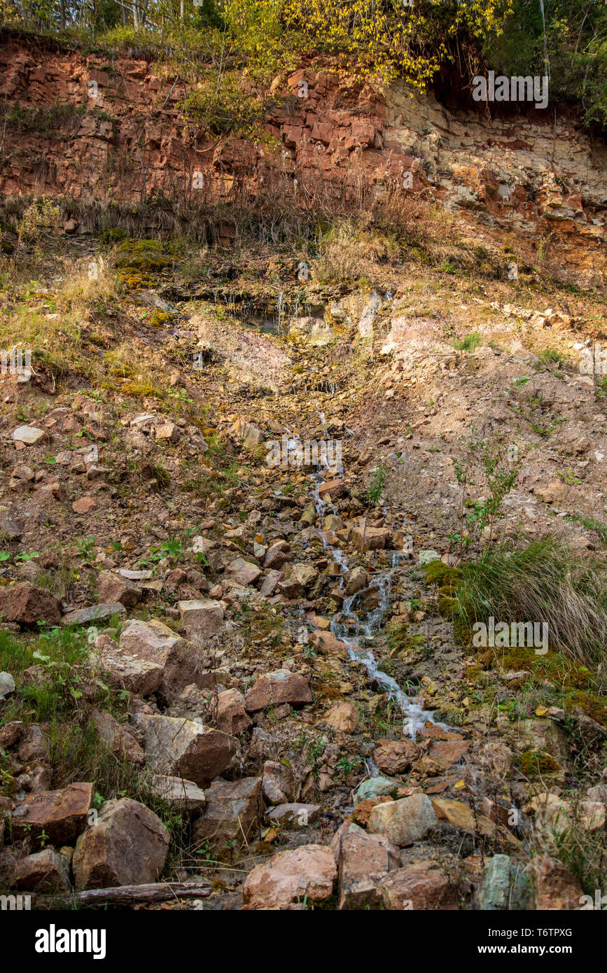 sandstone cliffs with waterfall near river. small water fall Stock ...