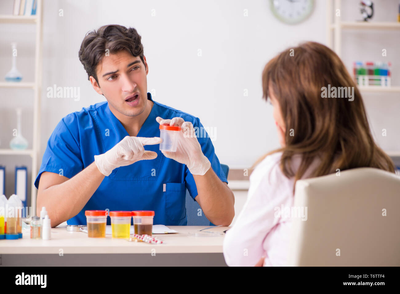 Patient visiting doctor for urine test Stock Photo - Alamy