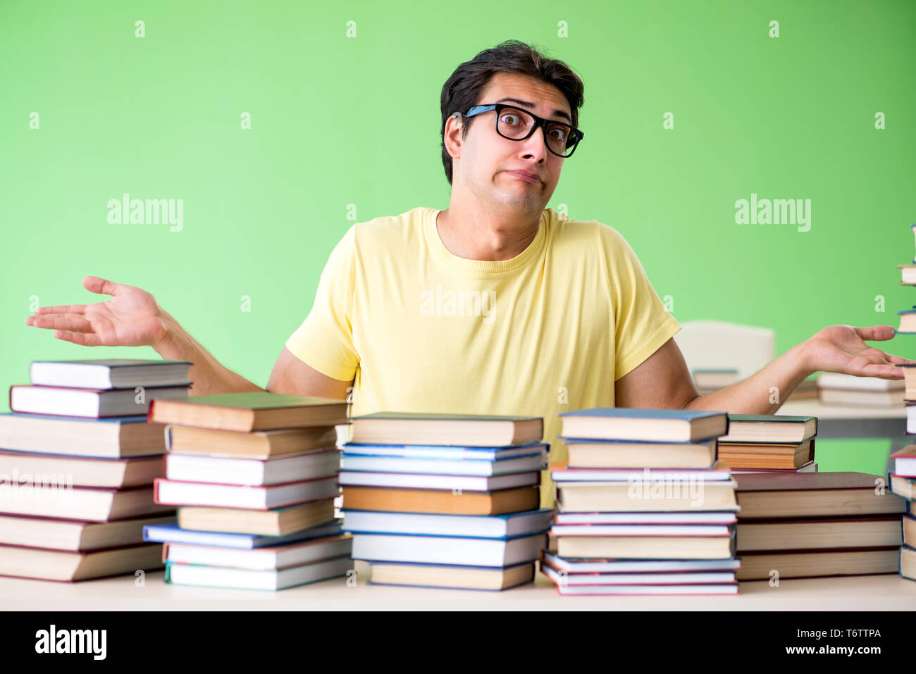Student with too many books to read before exam Stock Photo - Alamy