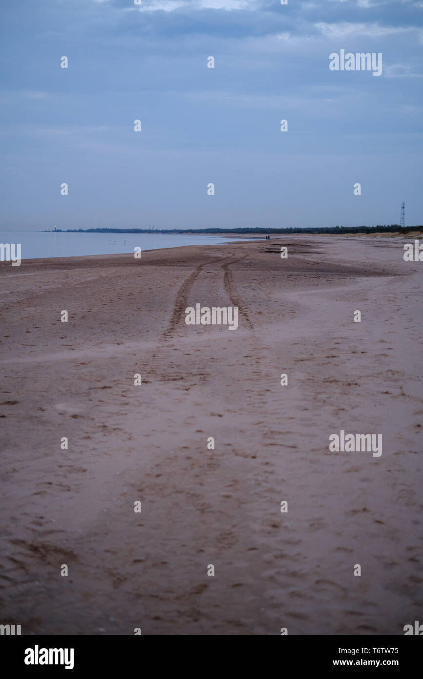calm sea beach on the shore of Baltic sea with blue clouds and low tide ...