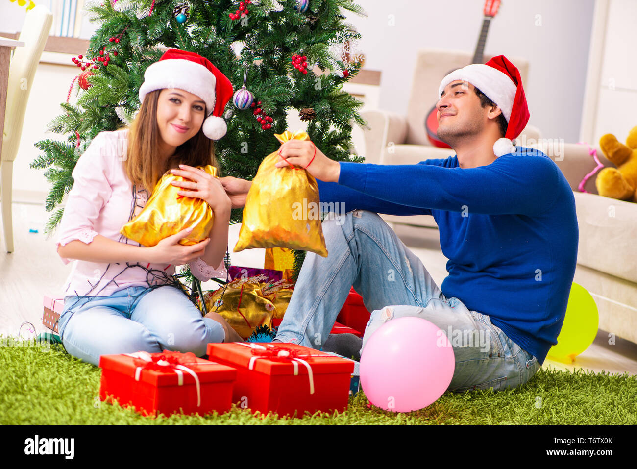 Excited couple opening christmas hi-res stock photography and images ...