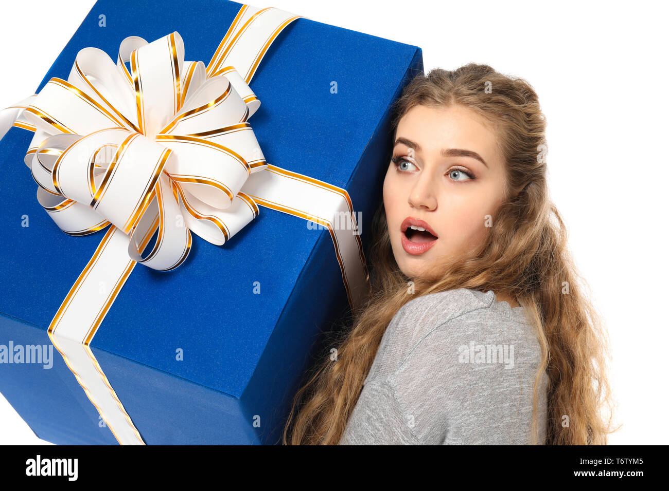 Surprised young woman with big gift box on white background Stock Photo ...