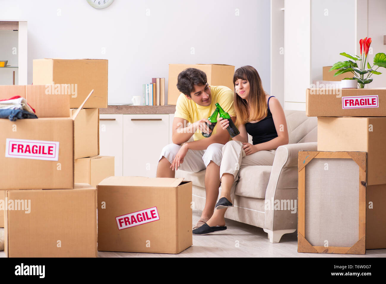 Young couple moving to new flat with fragile things Stock Photo - Alamy