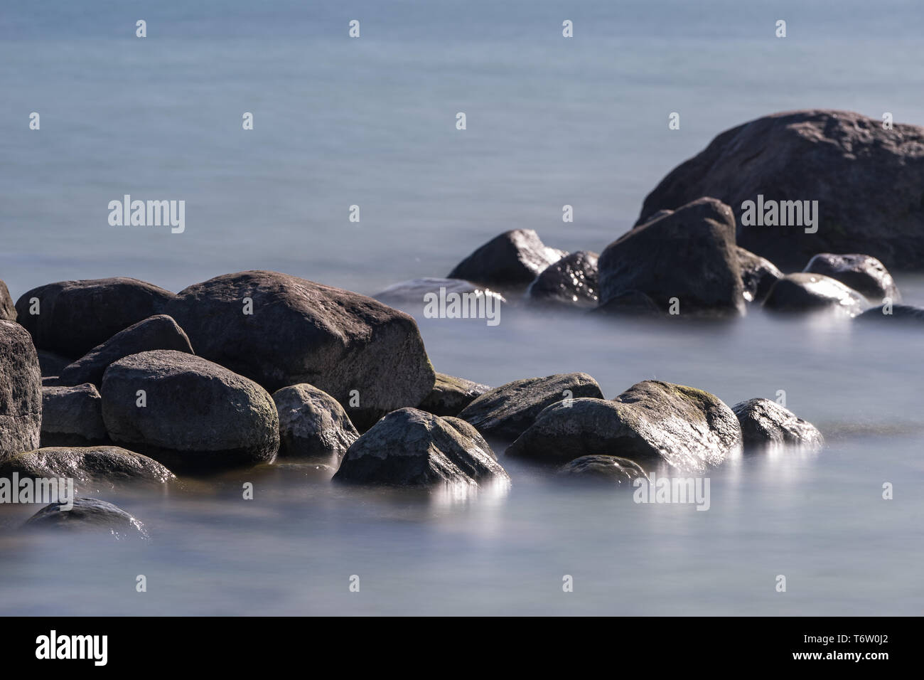 Calm blue see and big stones on the beachbeach Stock Photo - Alamy