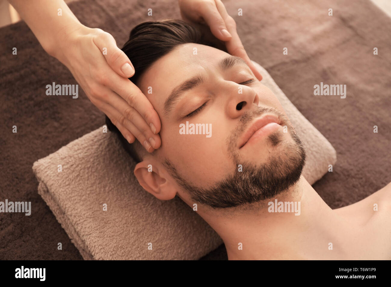 Young man receiving massage at spa salon Stock Photo - Alamy