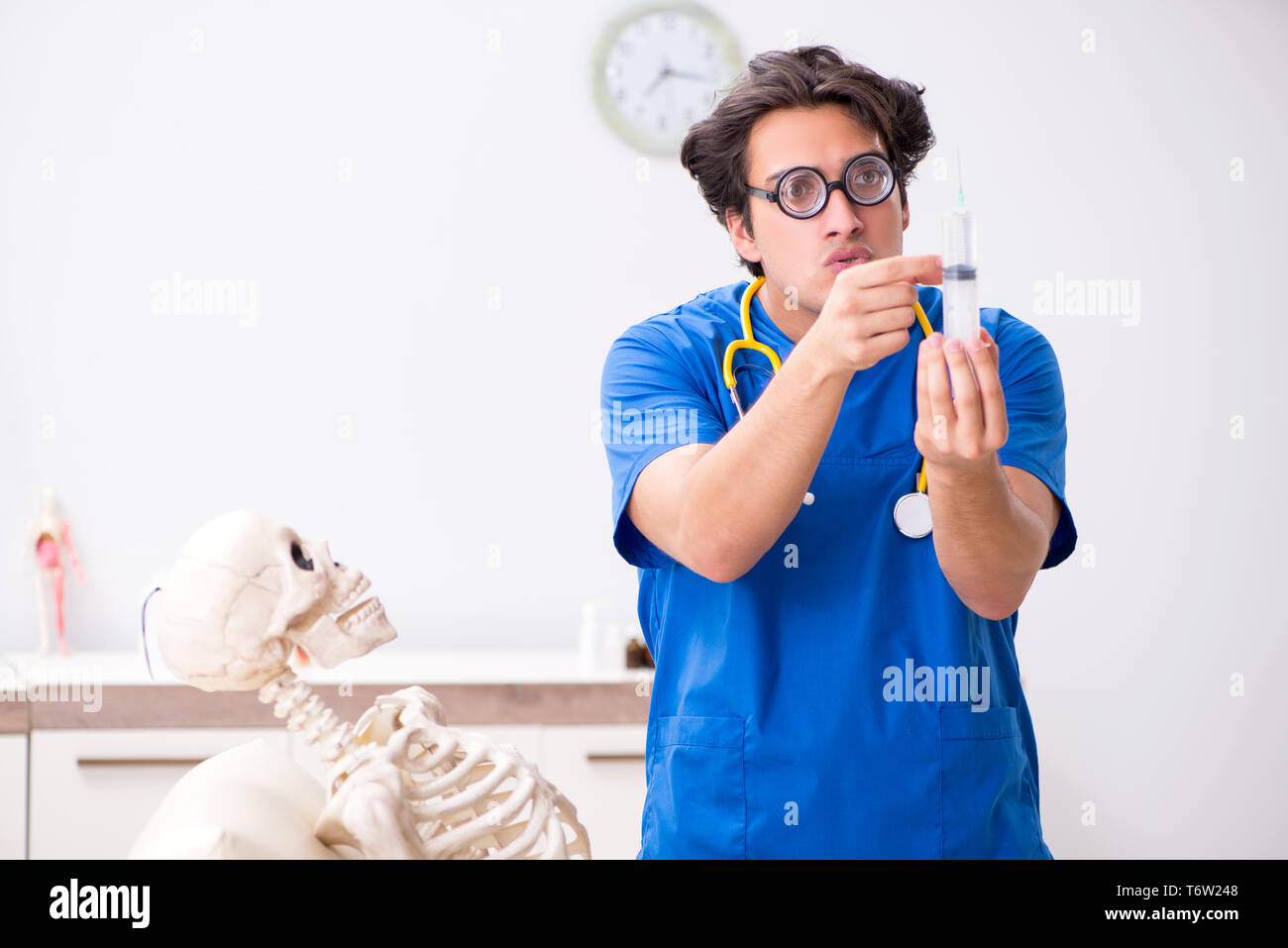 Funny doctor with skeleton in hospital Stock Photo - Alamy