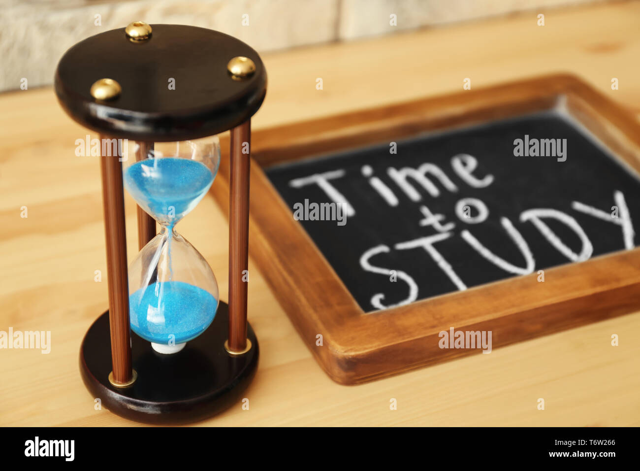 Hourglass and chalkboard on wooden table. Time management concept Stock ...