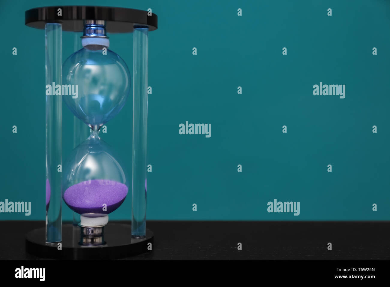 Hourglass on color background. Time management concept Stock Photo - Alamy