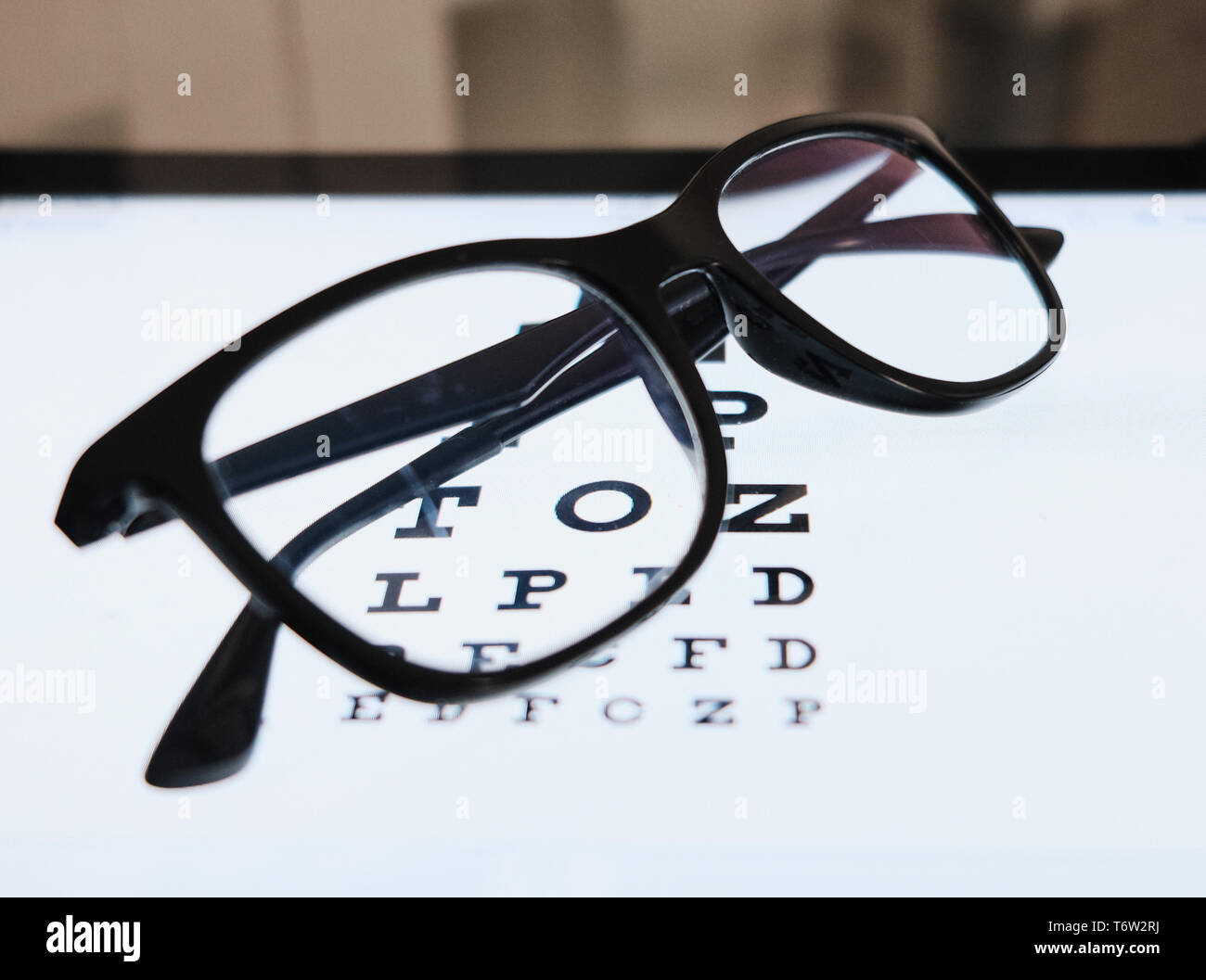 eye chart on tablet and the glass with E Standard Logarithm Eyesight ...
