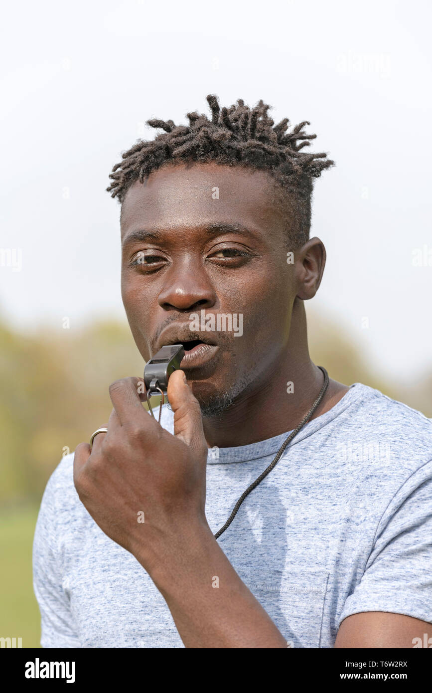 Blowing whistle and uniform hi-res stock photography and images - Alamy