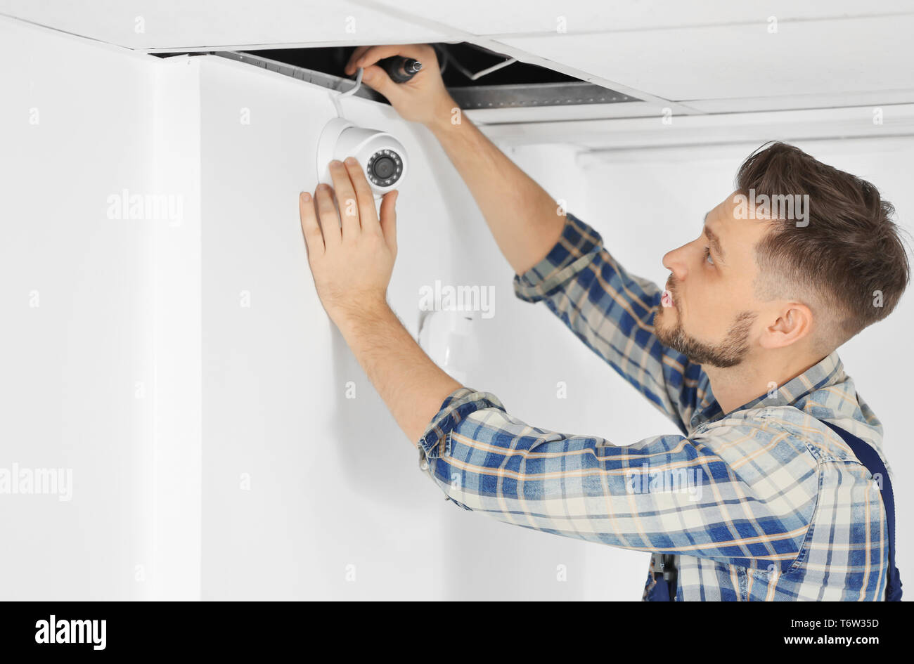 Electrician installing surveillance camera Stock Photo - Alamy