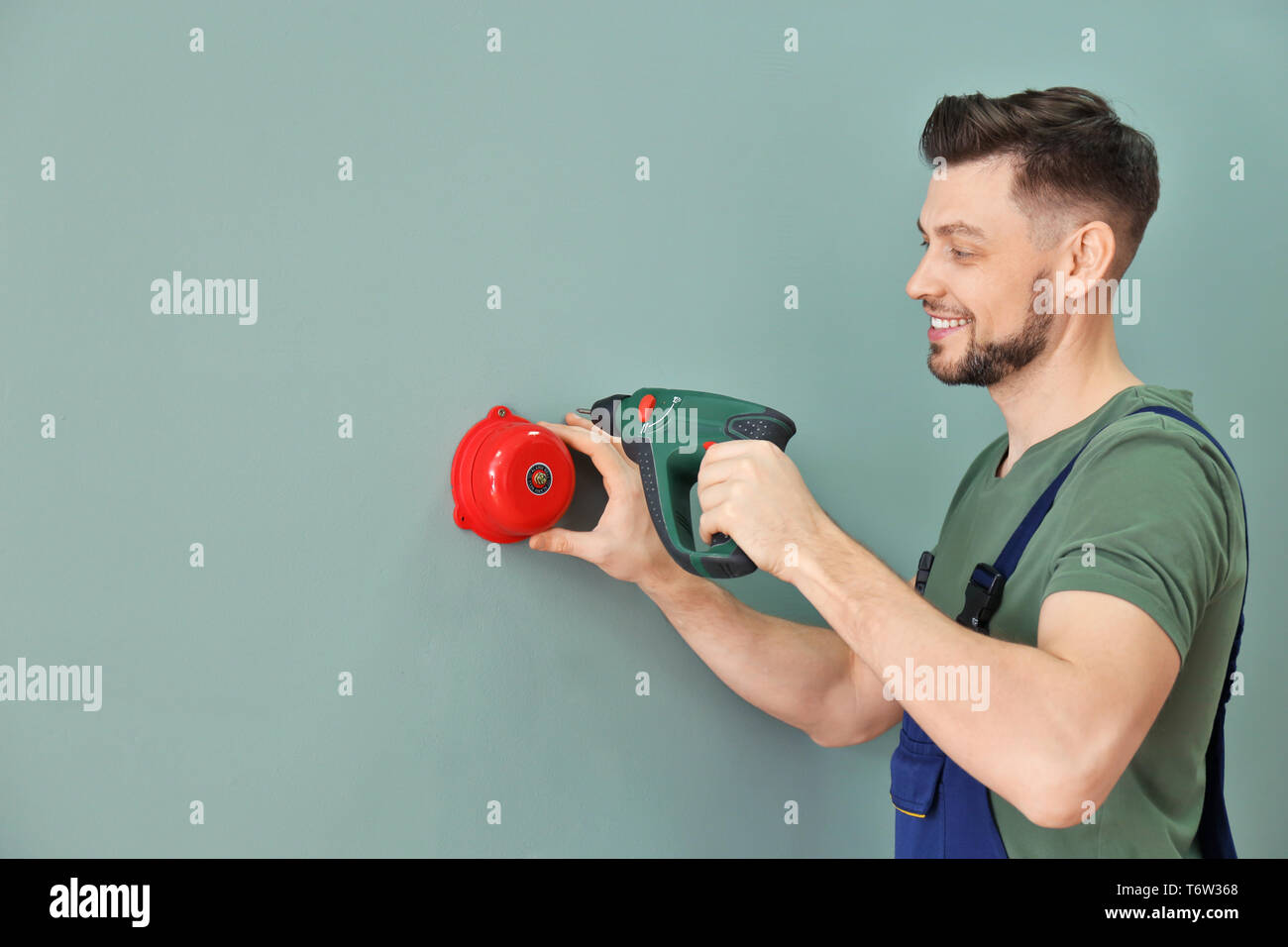 Electrician installing alarm bell Stock Photo - Alamy