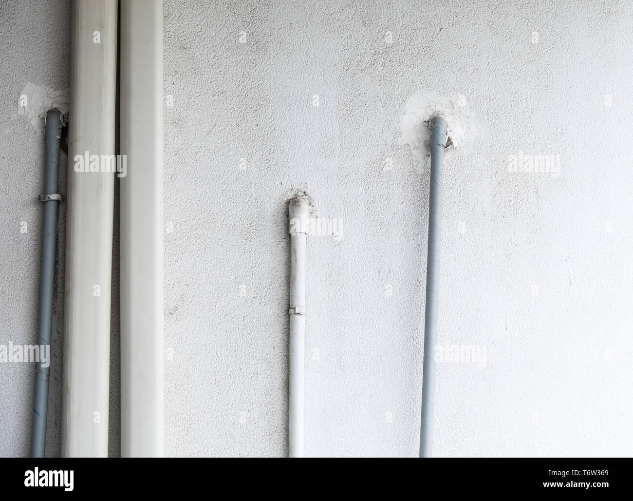 PVC pipe of the air conditioner system on the white concrete wall Stock ...