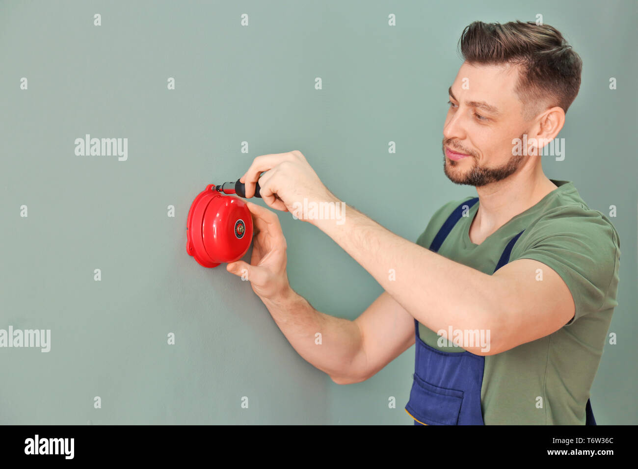 Electrician installing alarm bell Stock Photo - Alamy