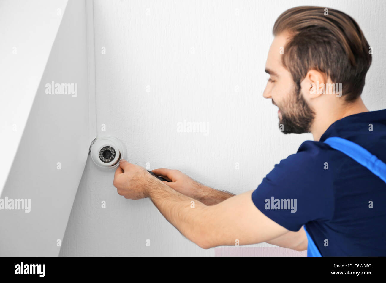 Electrician installing surveillance camera Stock Photo - Alamy
