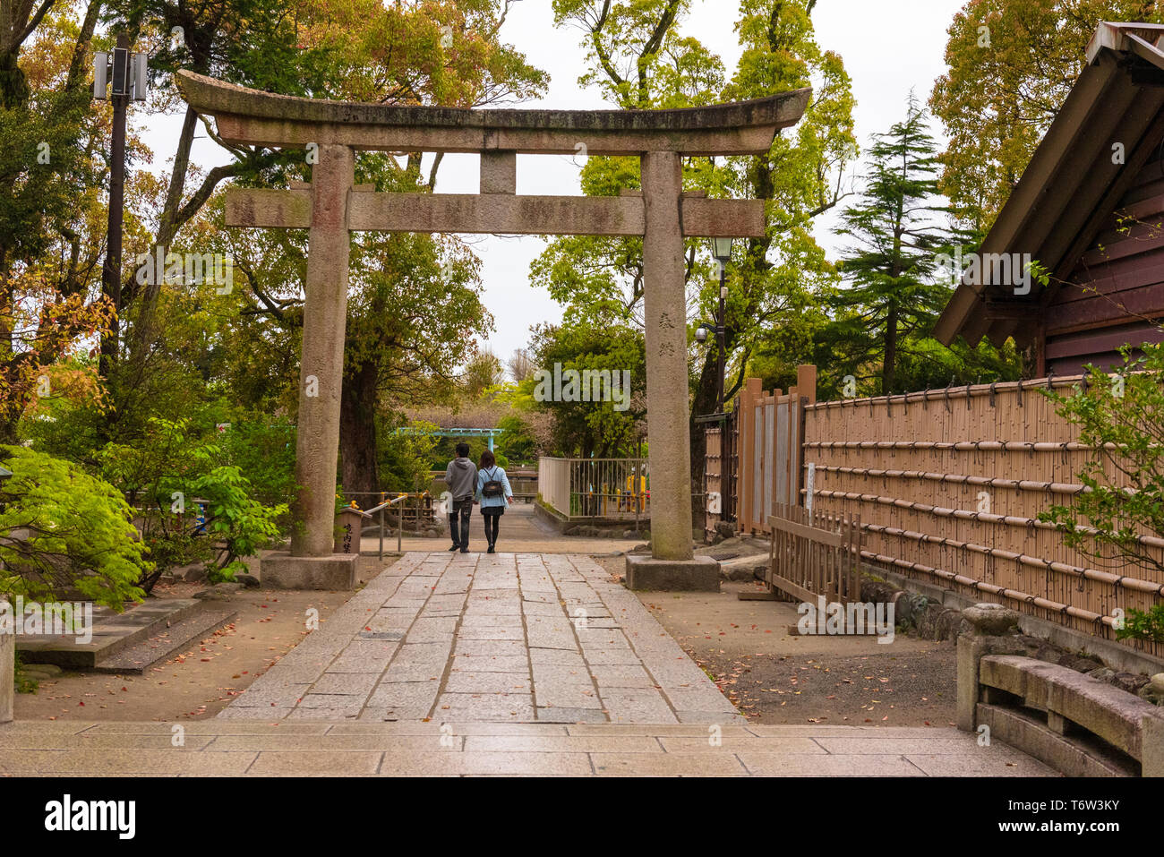Tokyo, Japan -- April 13, 2016. A man and woman take a walk in a park ...