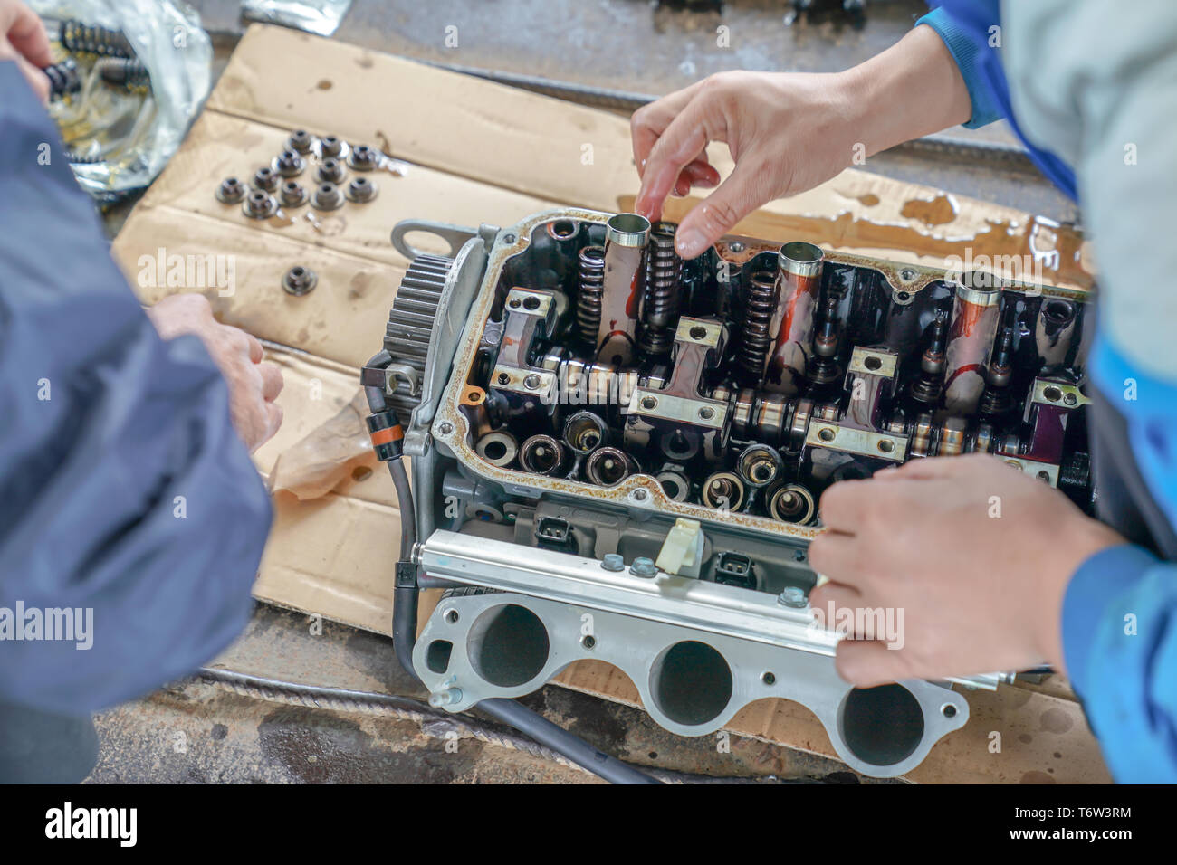 2 mechanic men try to fix and setup boat engine Stock Photo - Alamy