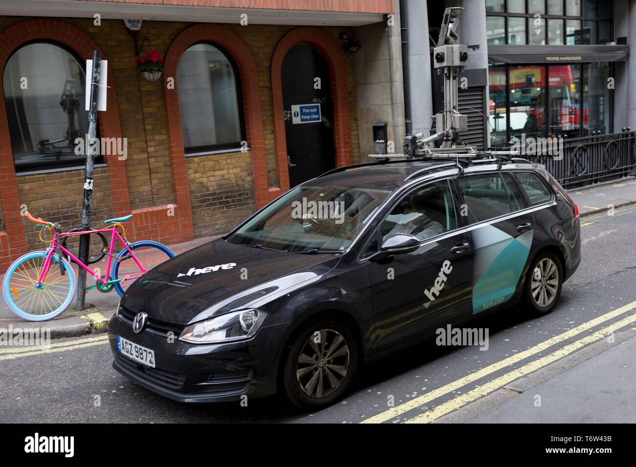 A data car with 'Here Technologies' and with roof-mounted cameras ...